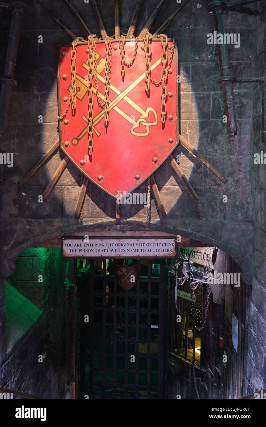 A red shield with a sword and key image, graphic, at the front entrance ...