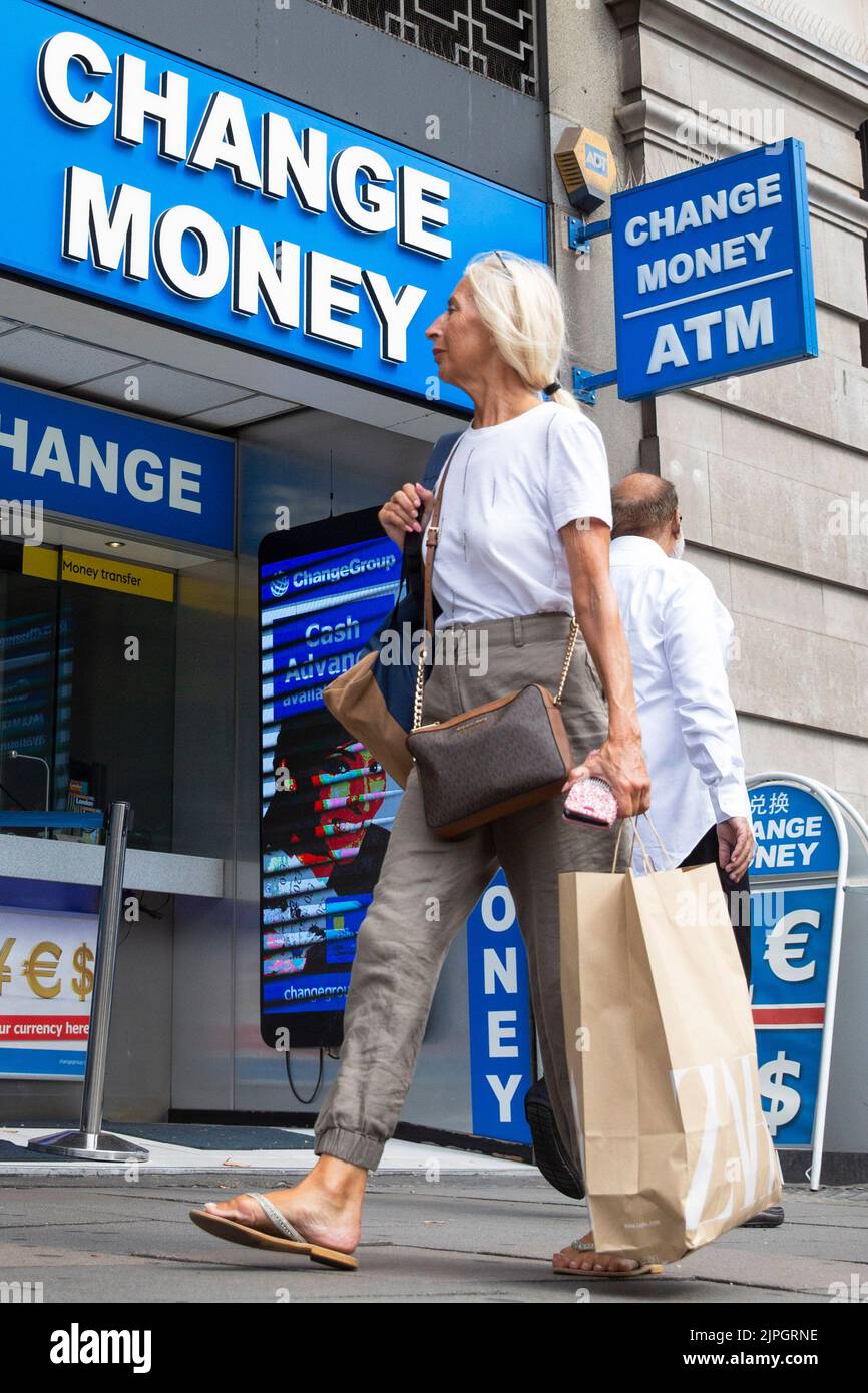 London ,United Kingdom -18/08/2022. A woman walks past a money ...