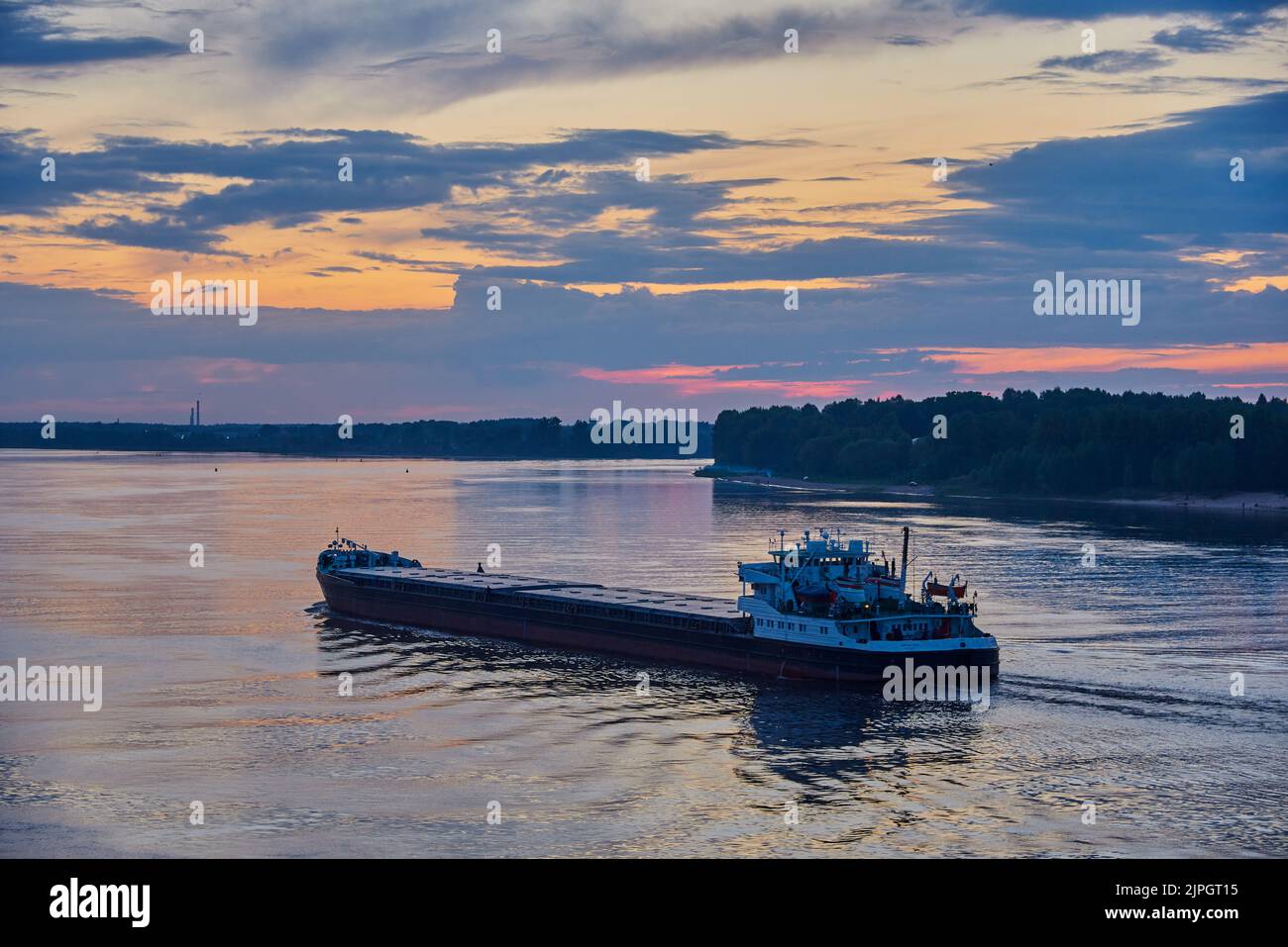 A barge floats on the river at sunset. Summer evening landscape Stock ...