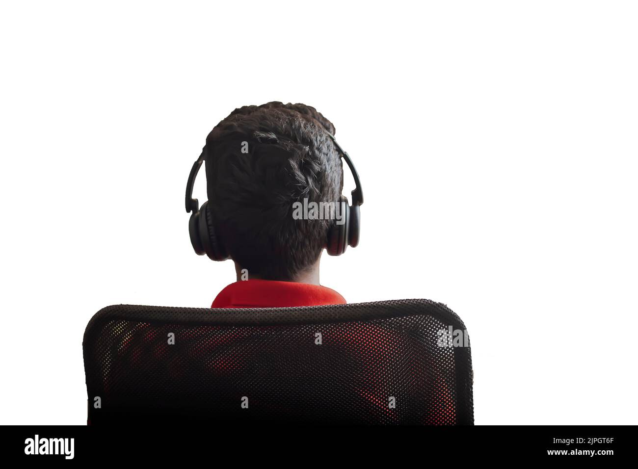 The handsome happy guy sits in a black chair with headphones on and ...