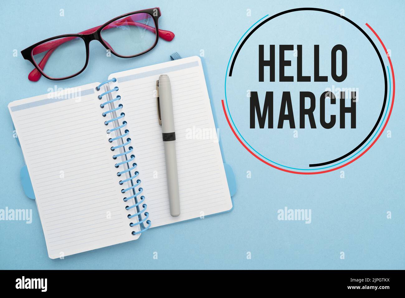 A writing displaying text 'Hello March' with notepad and glasses in ...