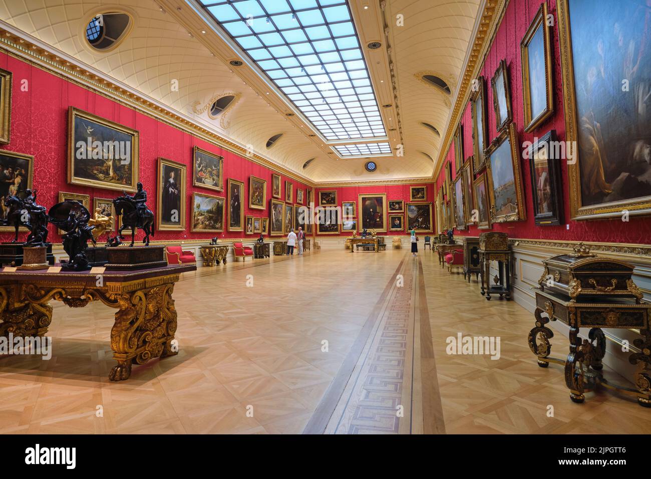 Interior view of the large, red wallpaper salon with many Old Master ...