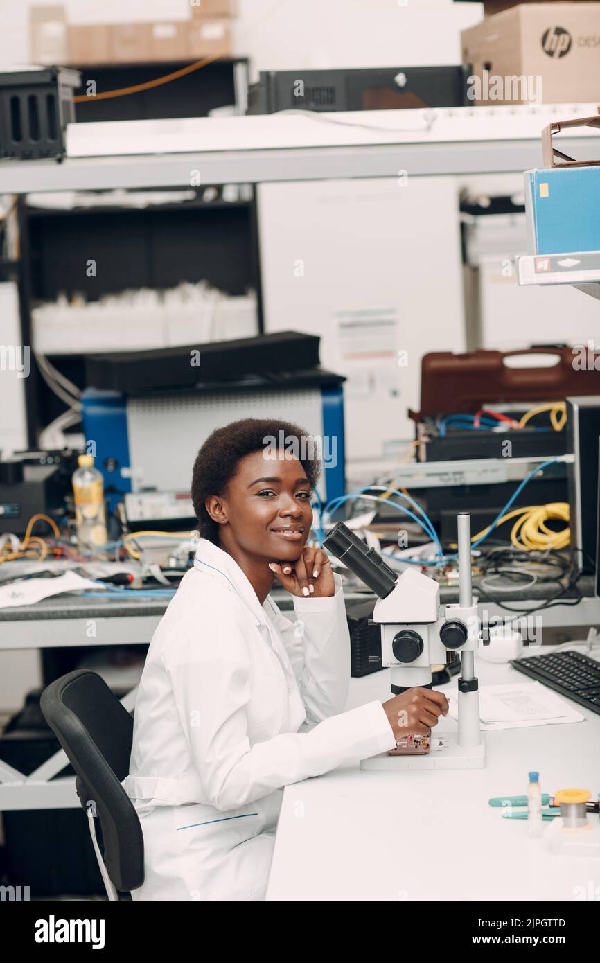 Scientist african american woman working in laboratory with electronic ...