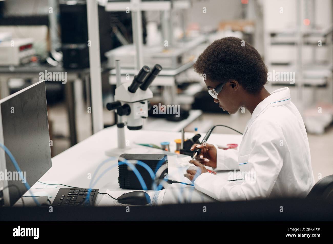 Scientist african american woman working in laboratory with soldering ...