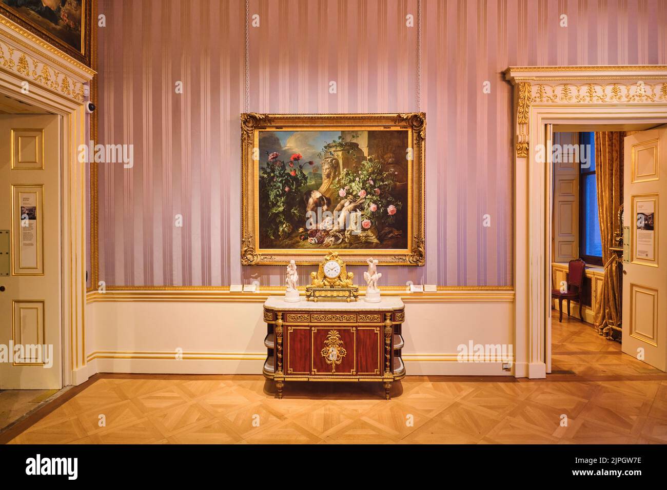A fancy sideboard under a painting featuring a hunting dog and wild ...