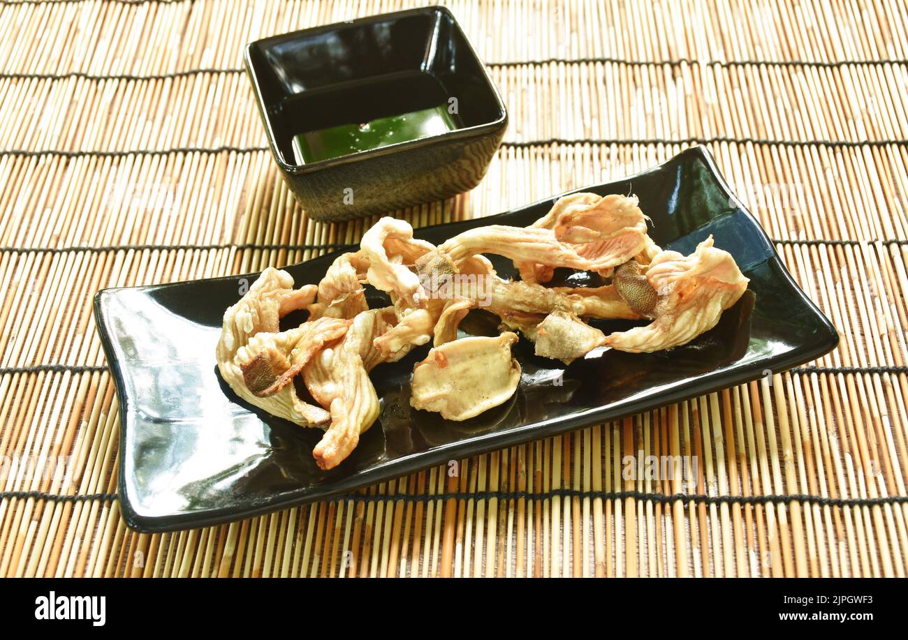 crispy fried duck innards on plate dipping with sweet black soy sauce ...