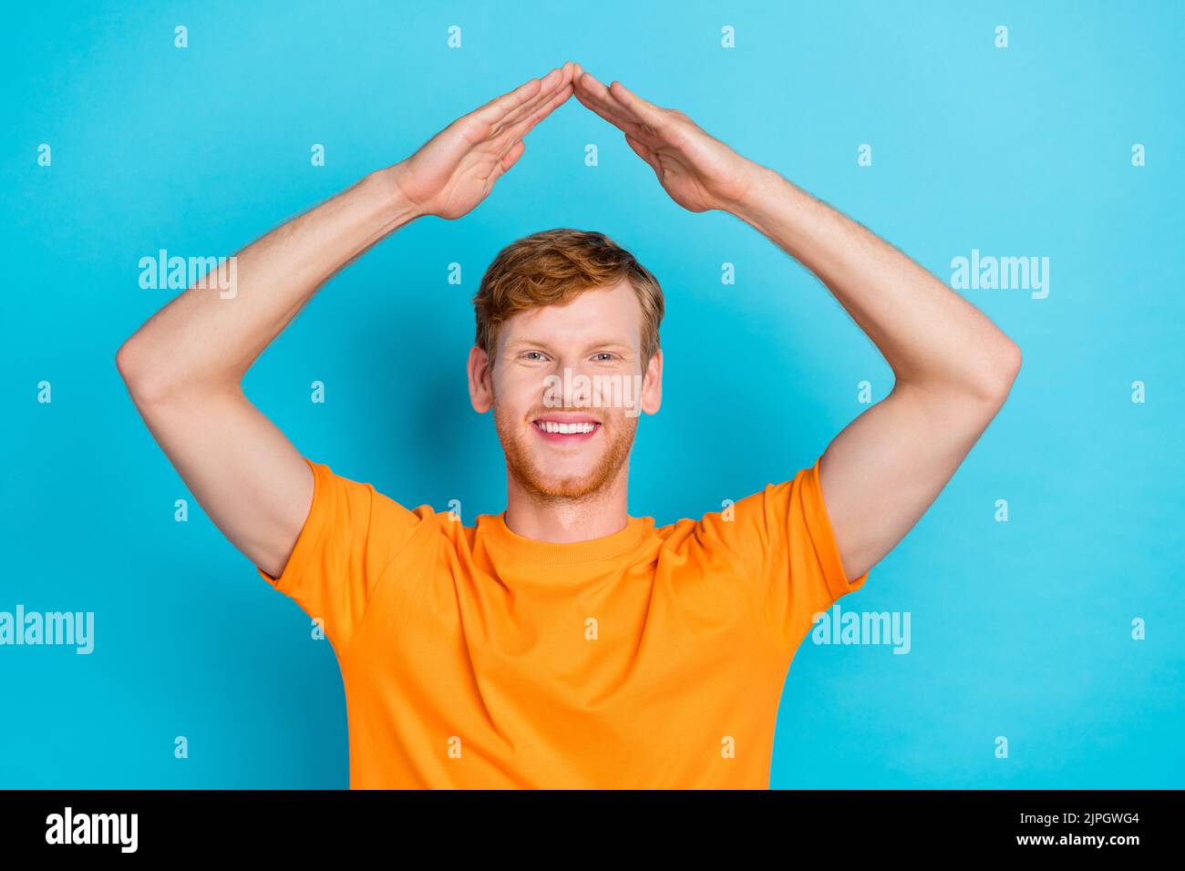 Photo of impressed ginger hair guy arms roof wear orange t-shirt ...