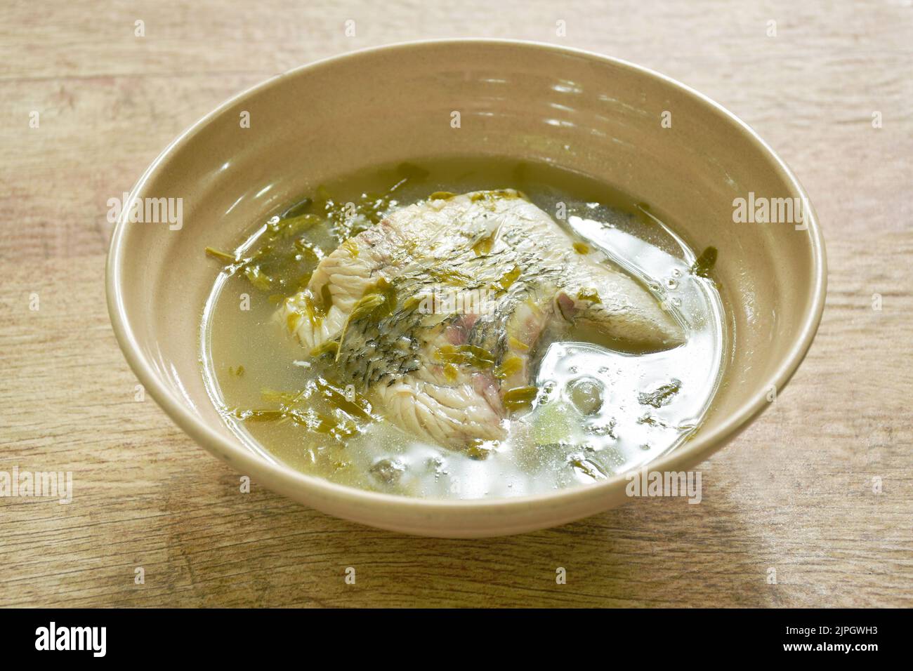 spicy bass fish head and tamarind leaf in Tom Yum soup on bowl Stock ...
