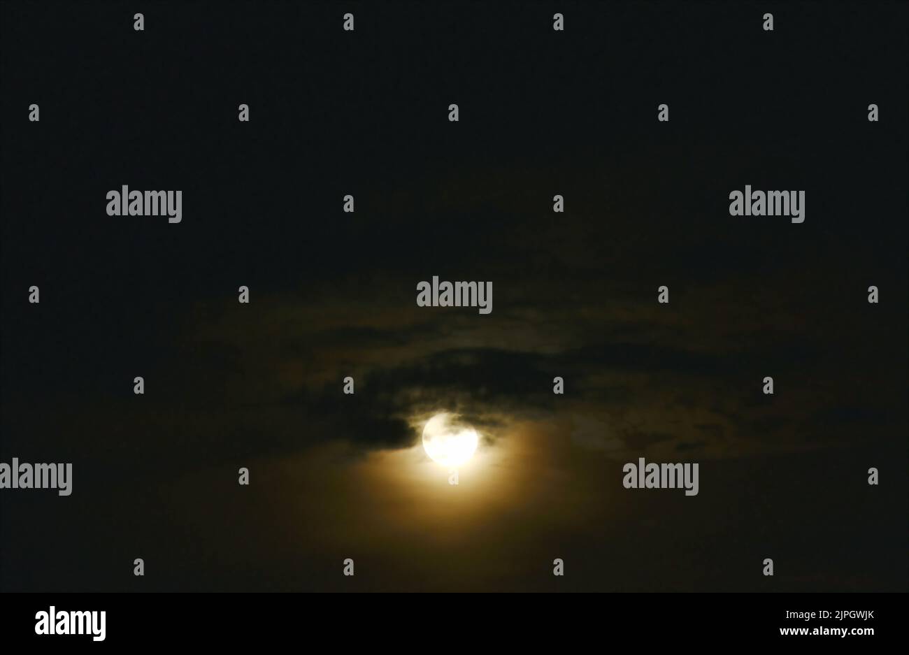 yellow full moon cover by spreading cloud in night Stock Photo - Alamy