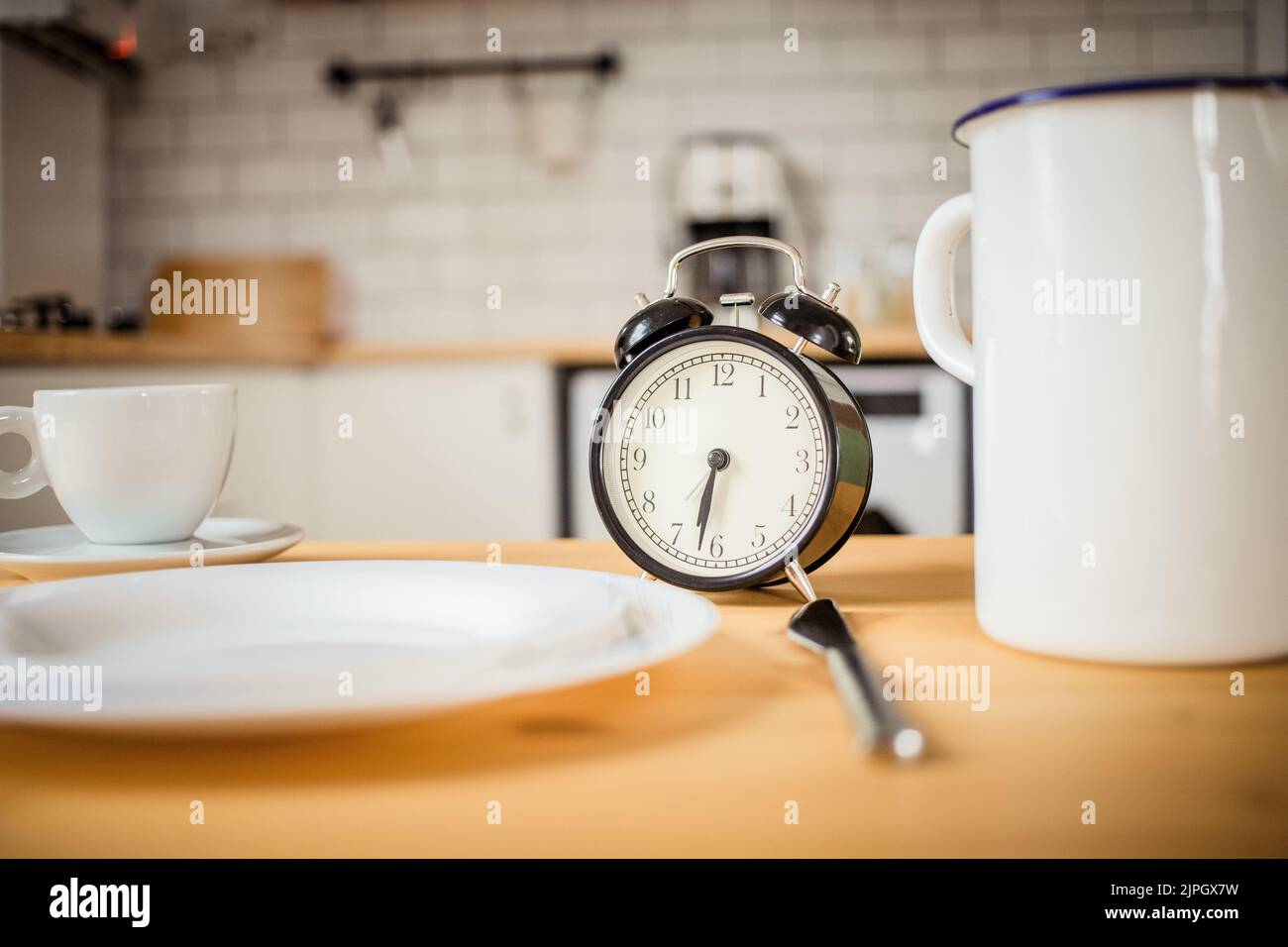 intermittent fasting concept alarm clock on kitchen table Stock Photo ...