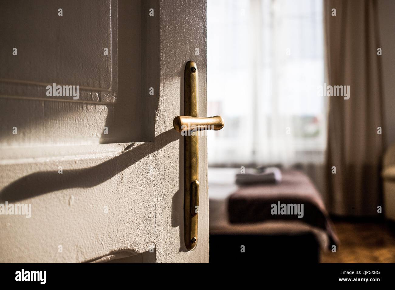 vintage white door opening into bedroom Stock Photo - Alamy