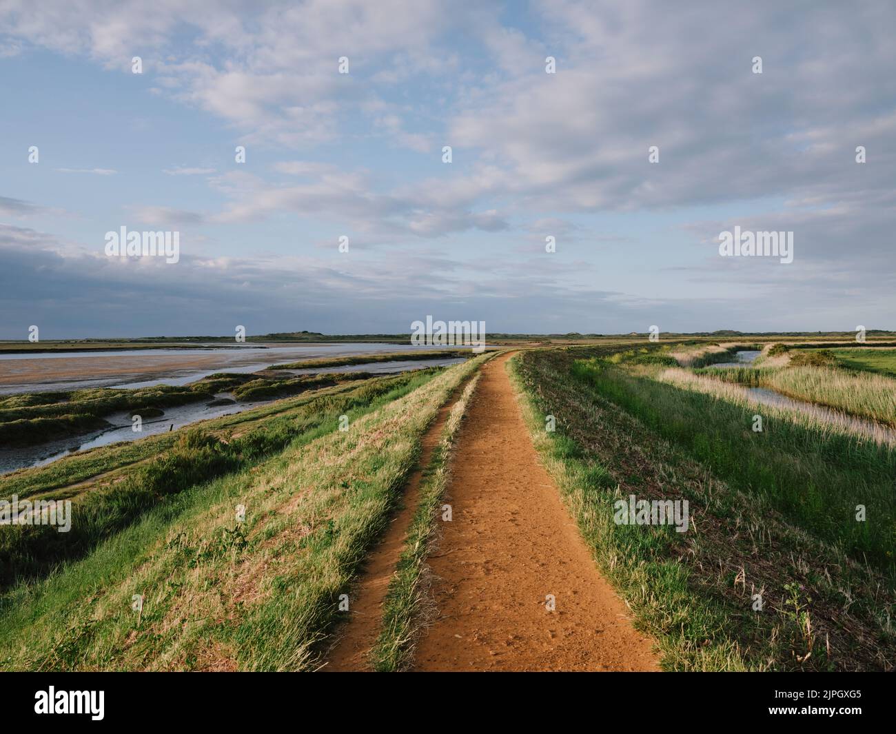 Walking the raised Norfolk Coastal Path at Burnham Overy in the summer ...