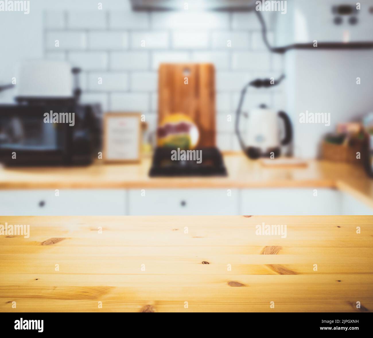 empty wooden tabletop and blurred kitchen mock up for product display ...