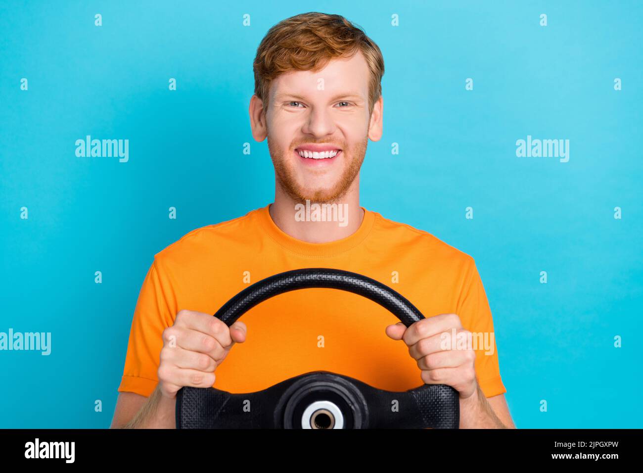 Photo of hooray ginger hair guy drive car wear orange t-shirt isolated ...