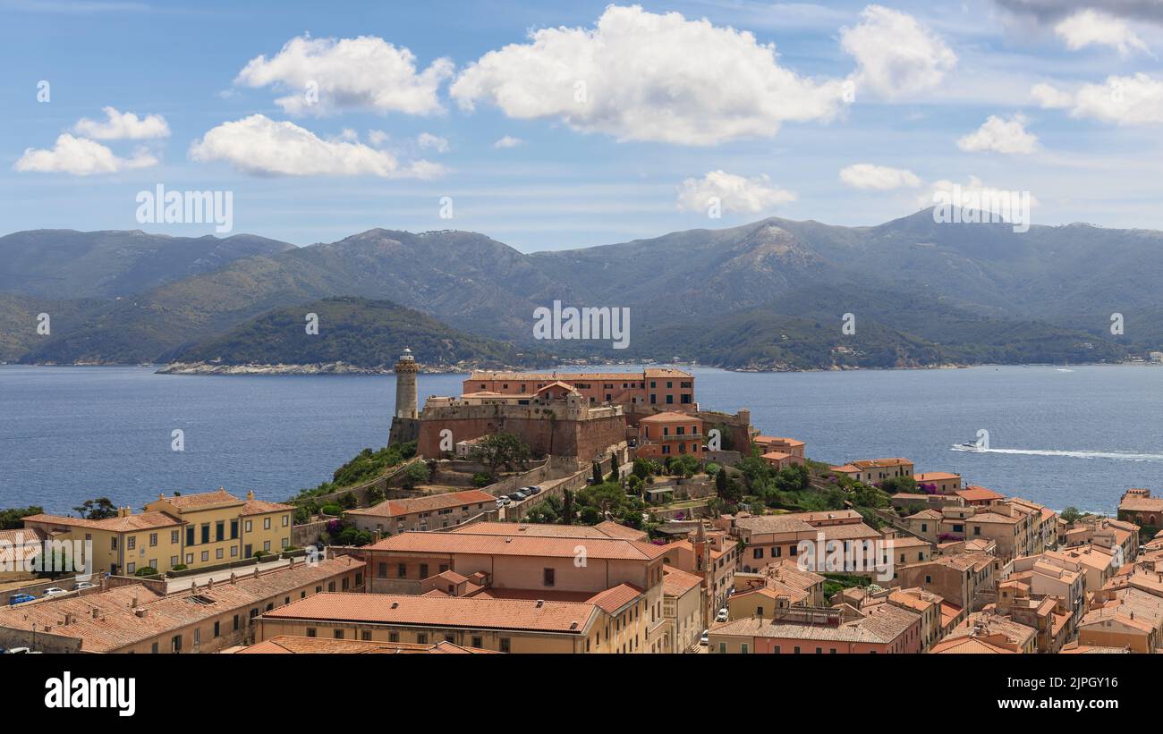 Orange tiled roofs of Portoferraio city's houses, Fort Stella towering ...