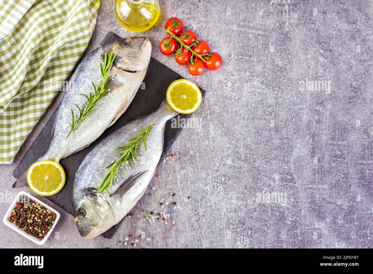 Fresh fish dorado and ingredients for cooking. Raw fish dorada with ...