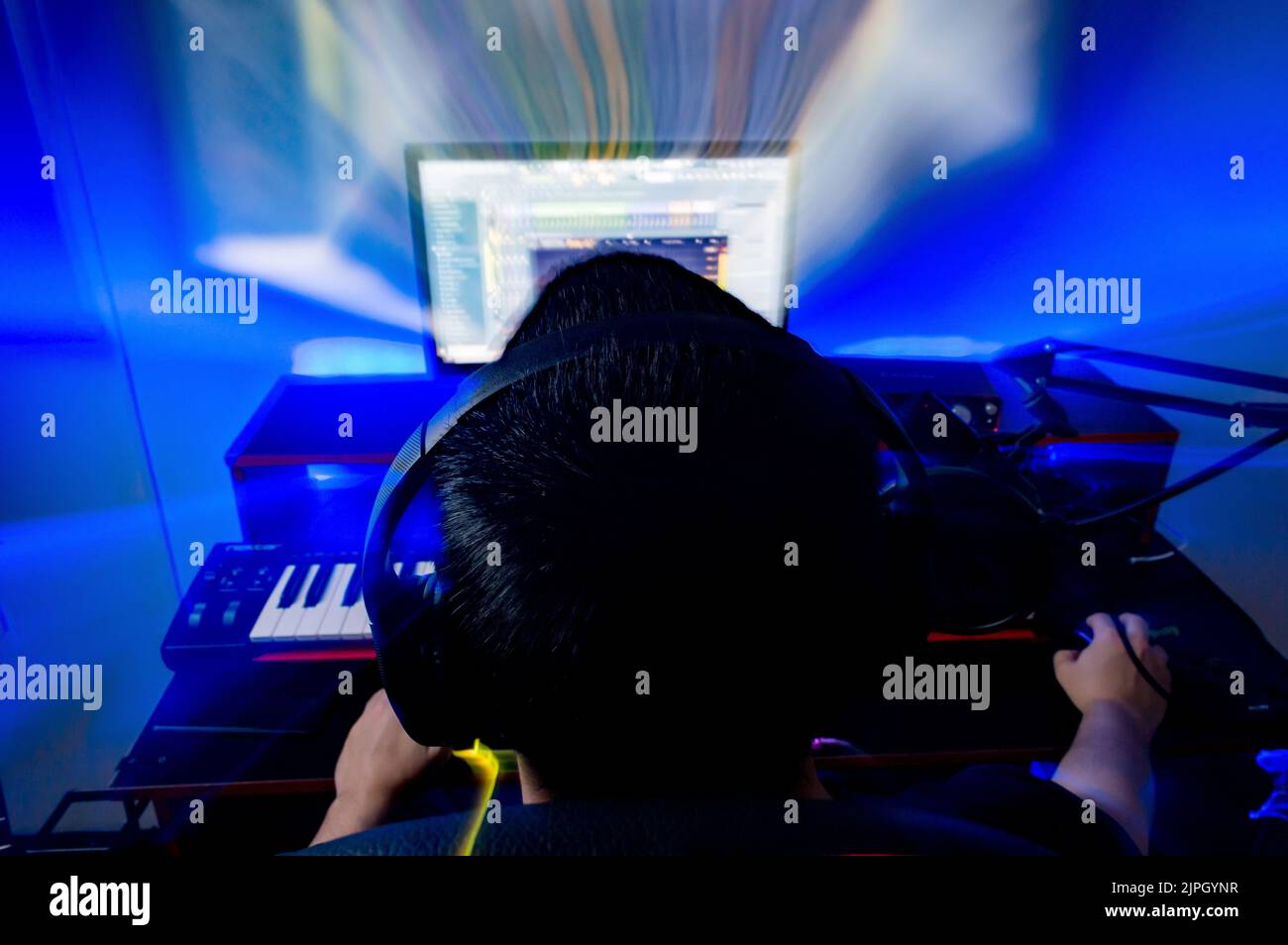 light painting image of young male music producer with headphones ...