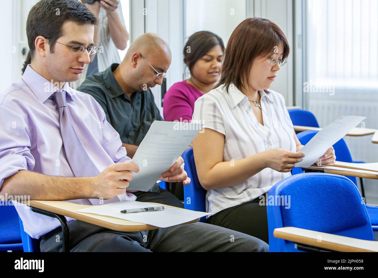 Adult Education, lecture notes. A group of mature students reading ...