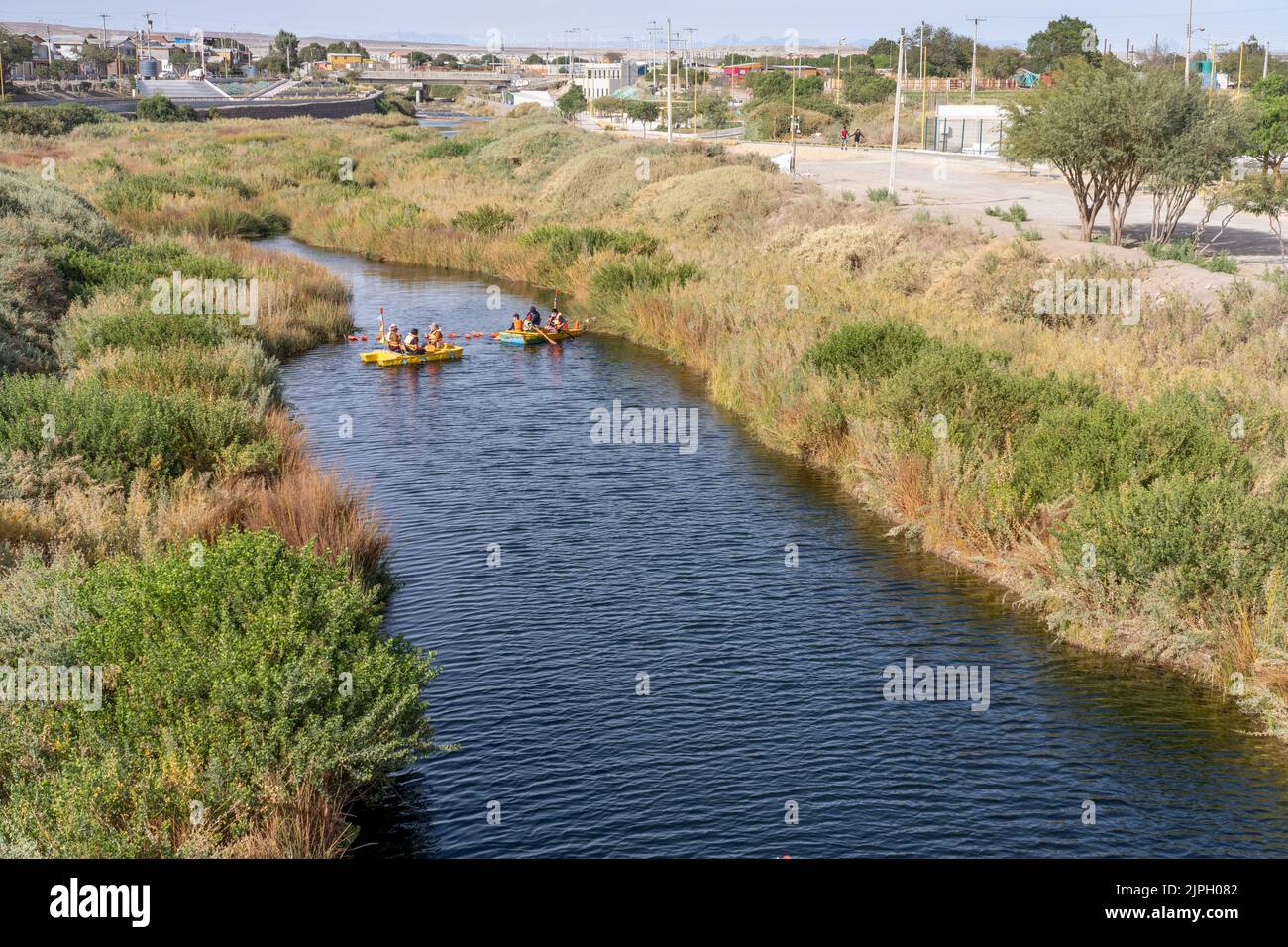Families in paddle boats on the Loa River in Calama in the Atacama ...
