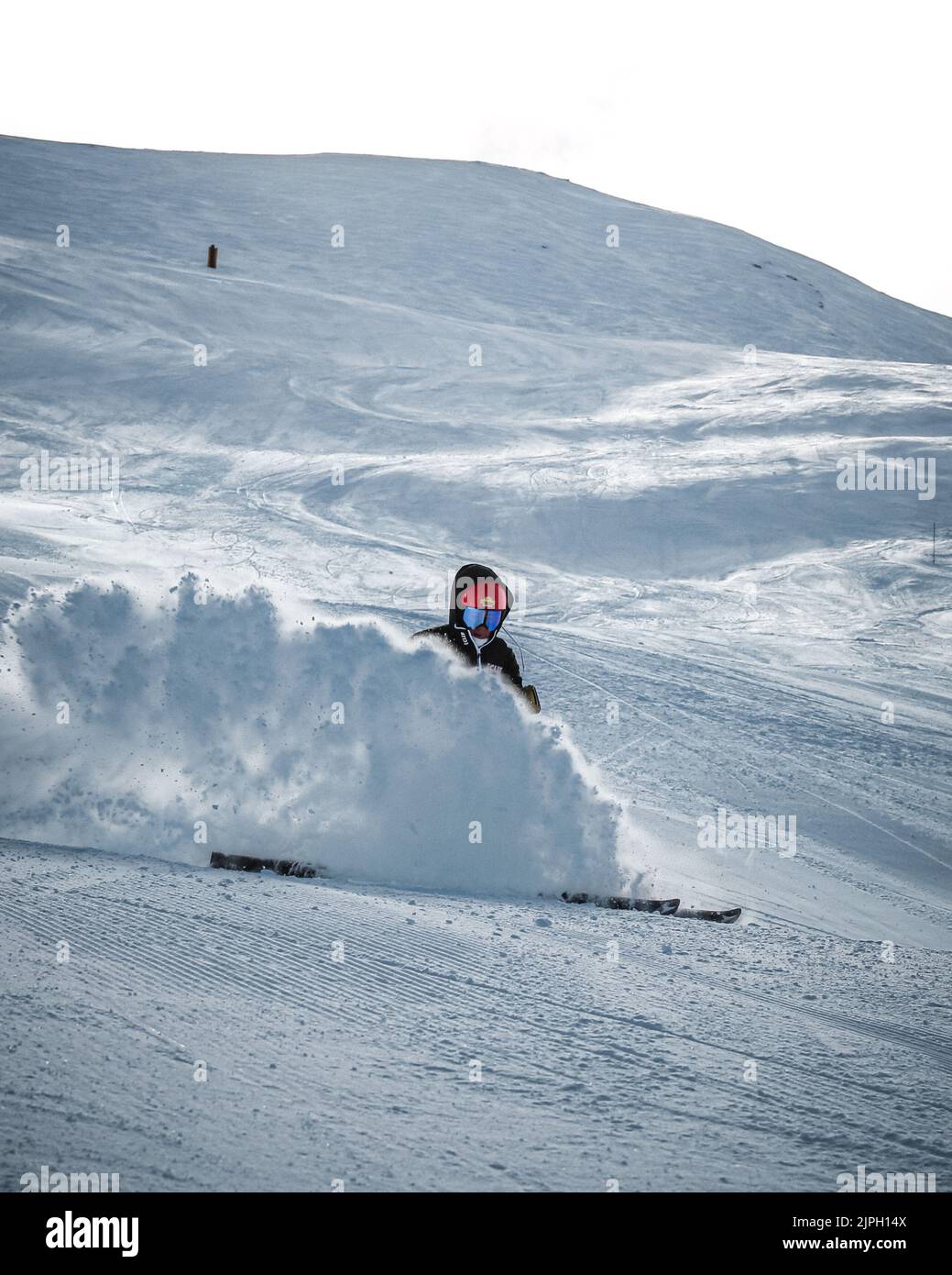 The vertical view of a person skiing on the snowy mountain slope Stock ...
