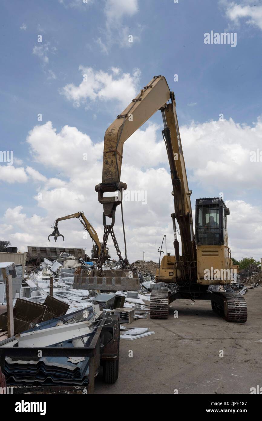 A large Caterpillar track material handler with an attached magnet ...