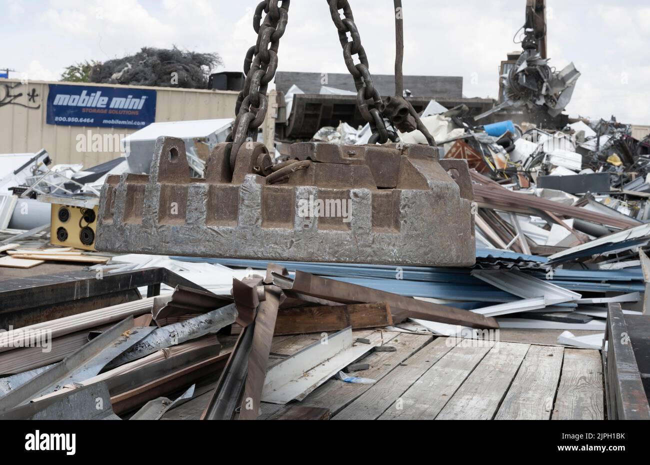 A large Caterpillar track material handler with an attached magnet ...