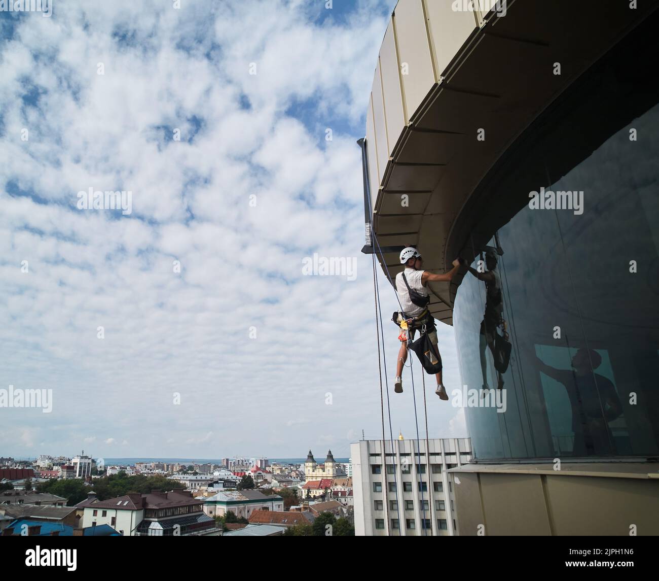 Industrial mountaineering worker professional window washer cleaning ...