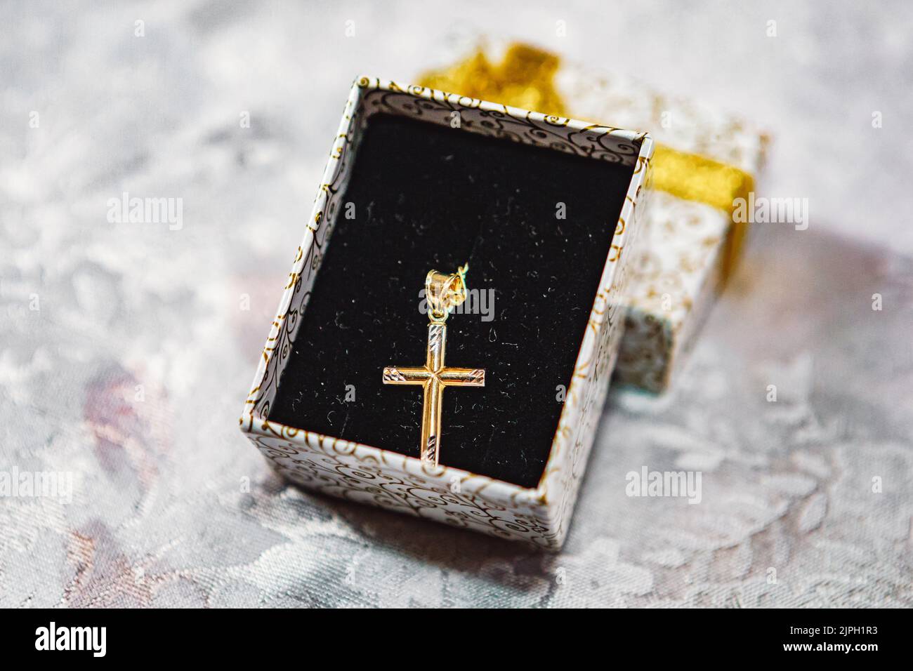 a cross in a box in a church during baptism Stock Photo - Alamy