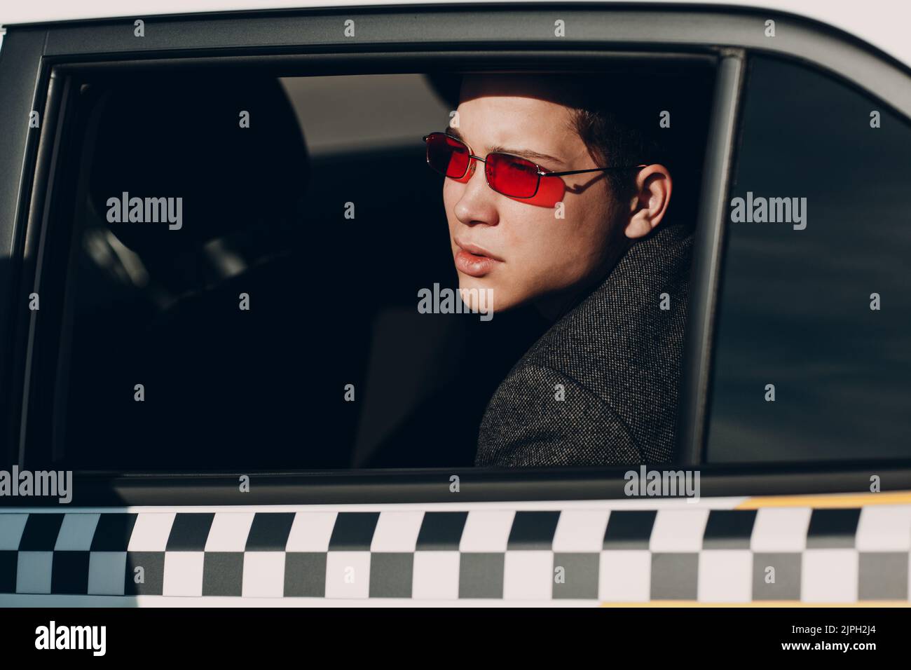 Portrait of a handsome young man riding in the backseat of taxi Stock ...