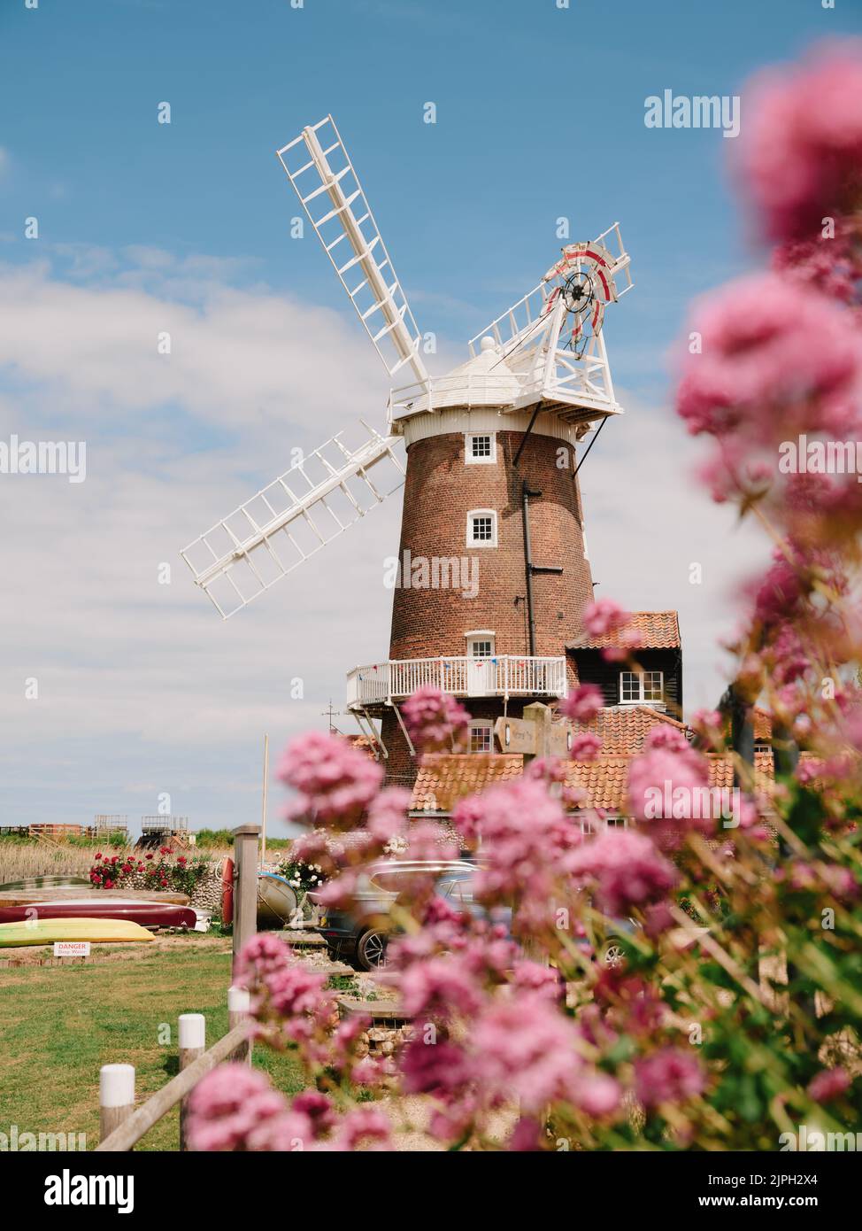 The 18th c Cley Windmill / Towermill and summer flowers on the North ...