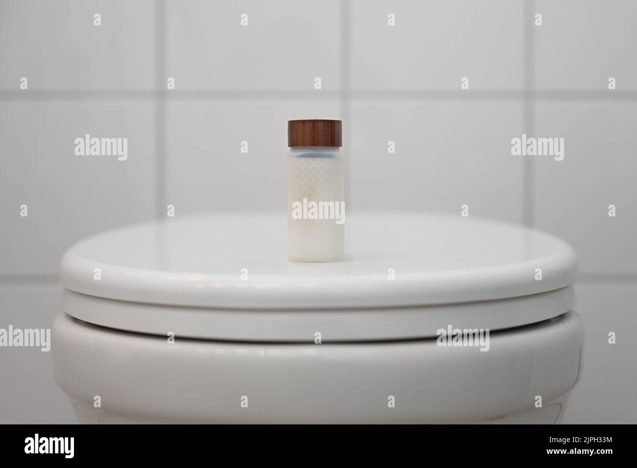 An empty plastic jar for stool sample with privacy protection to hide ...