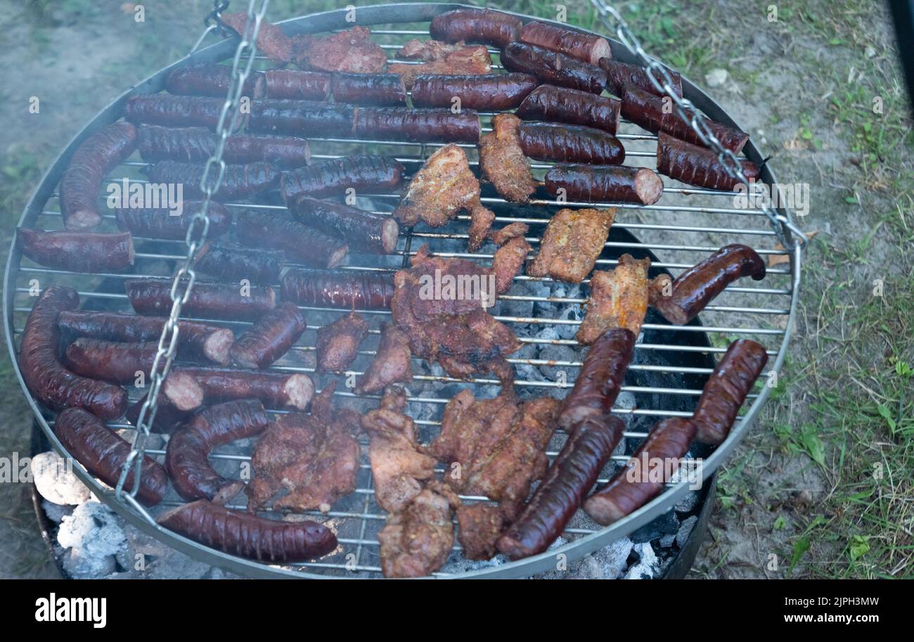 Grilling meat and sausages. Barbecue in the garden, hot coals in the ...