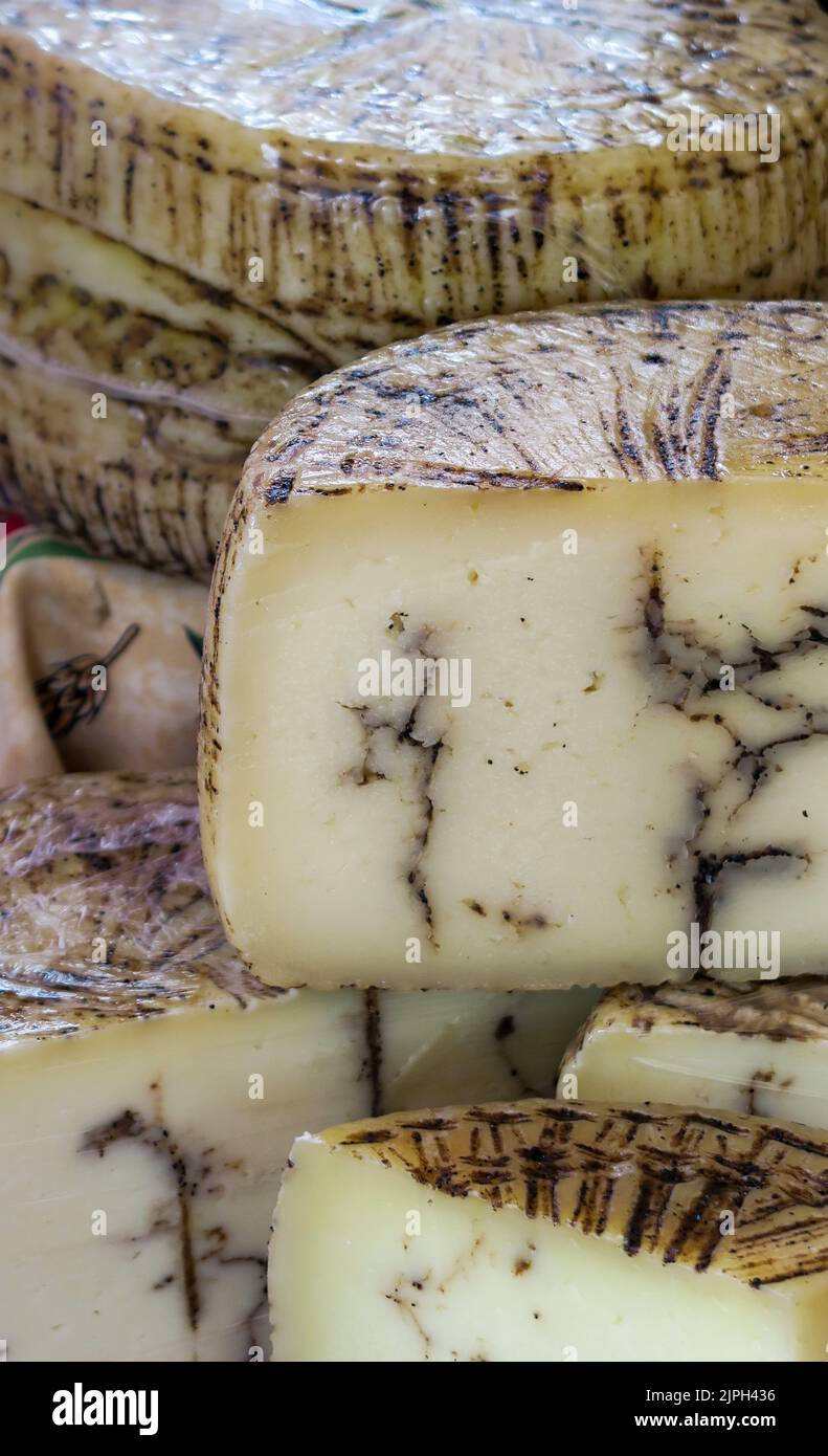 A vertical closeup of truffle cheese, cheese flavored with truffle ...