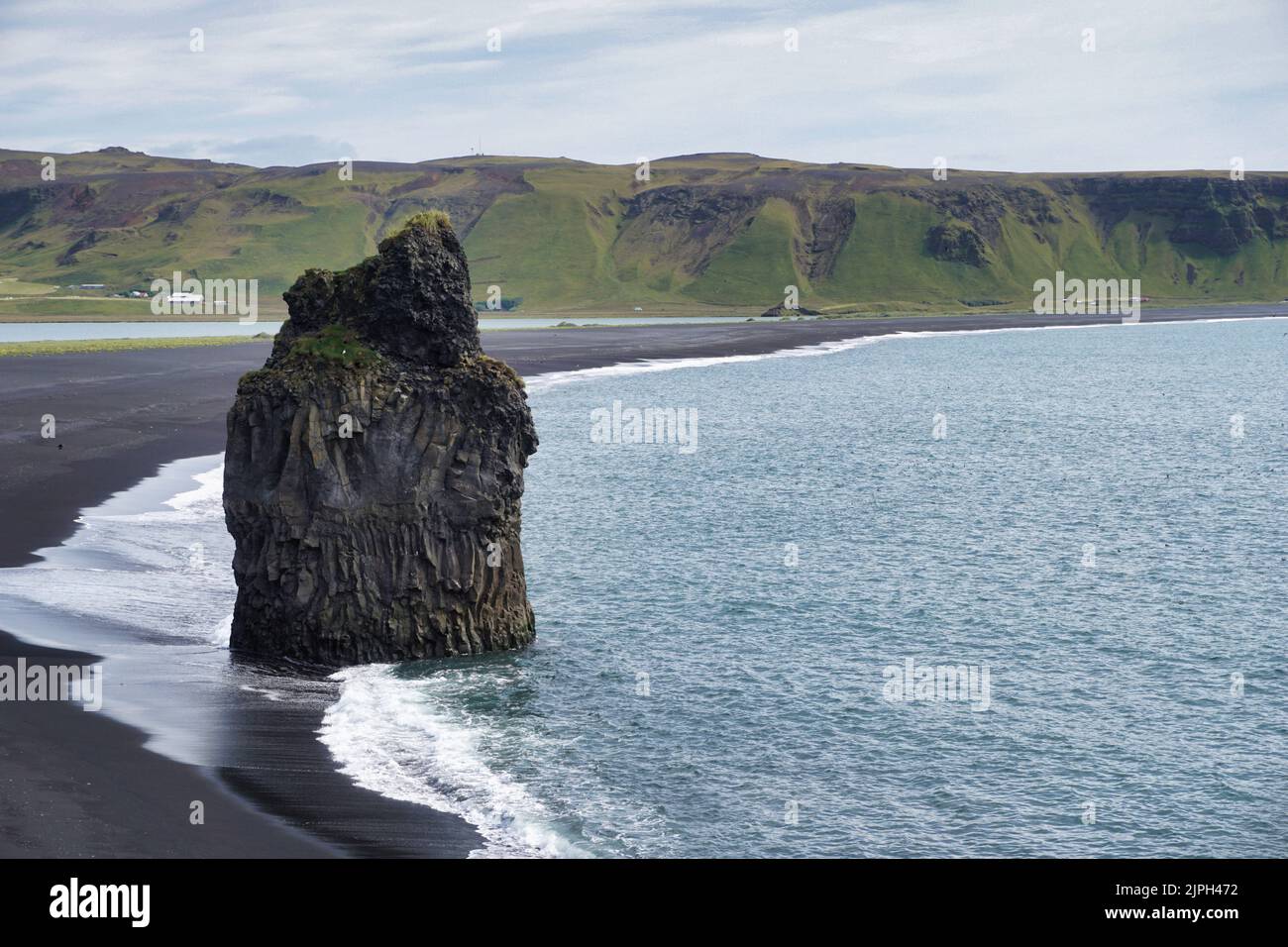Reynisfjara - black beach in Iceland, single rock and cliffs Stock ...