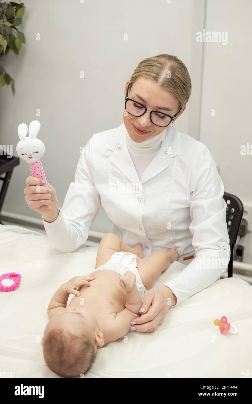 Female masseur doing baby massage for foot little infant baby child ...