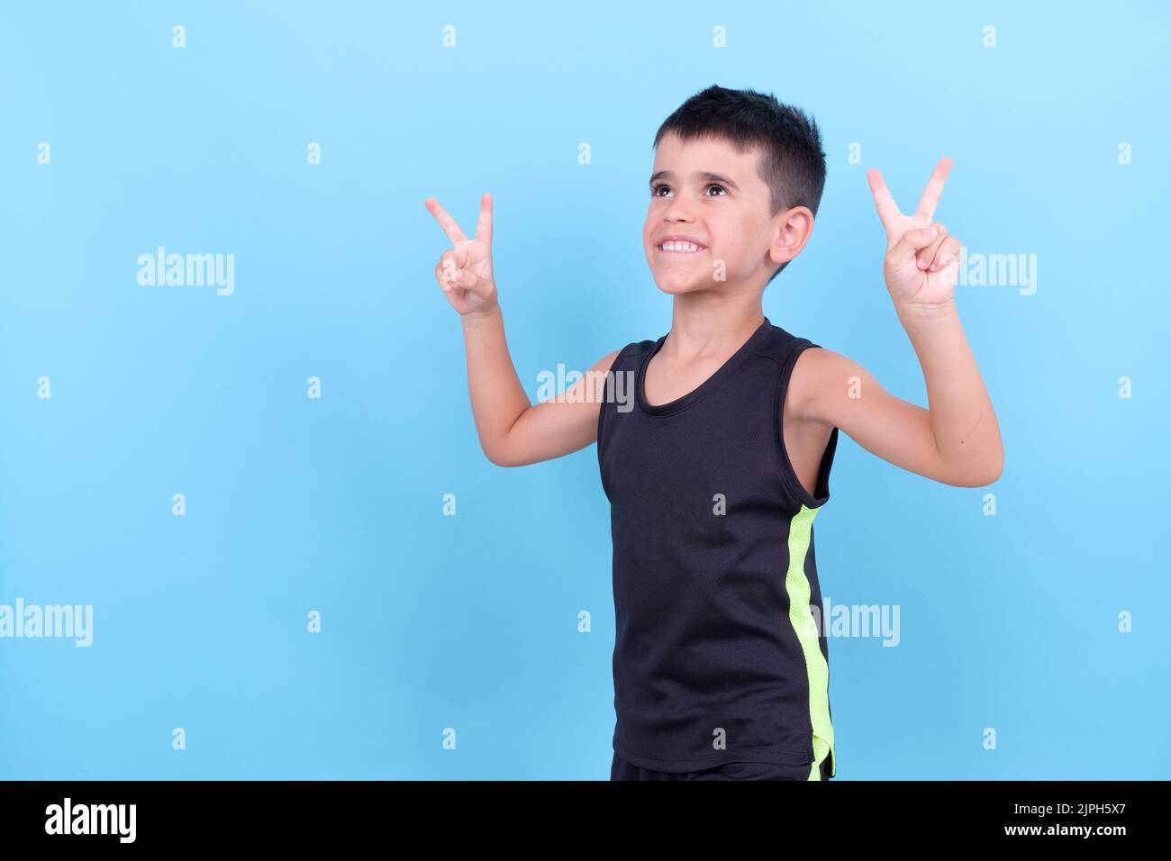 A child raises his arms with the symbol of victory Stock Photo - Alamy