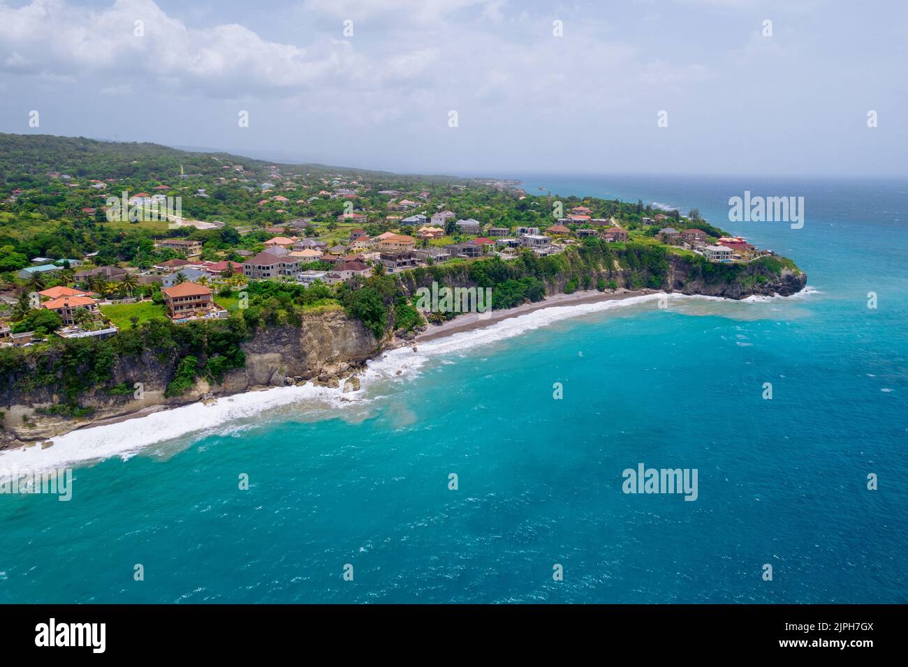 An aerial view of a small town with residential buildings on a cliff ...
