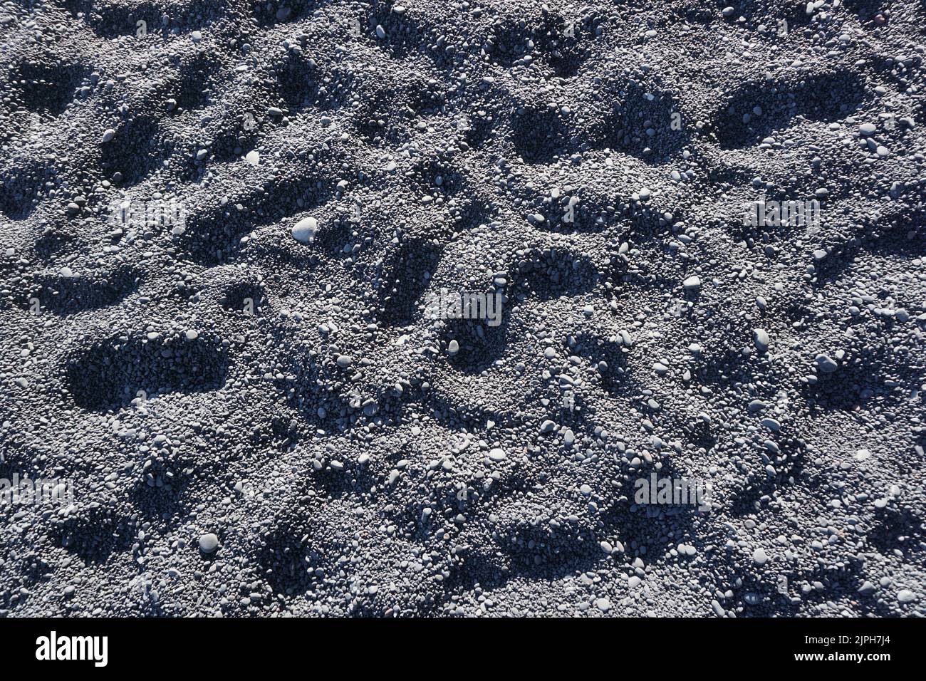 Black sand and pebbles - top view Stock Photo - Alamy