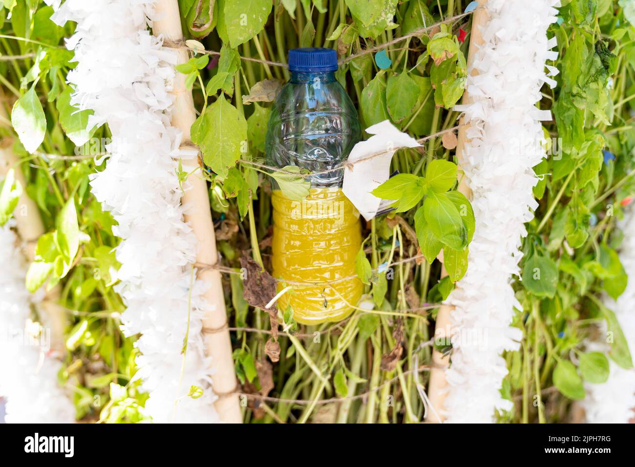 A bottle filled with Agua de Valencia hooked on a rope from an Alfabega ...