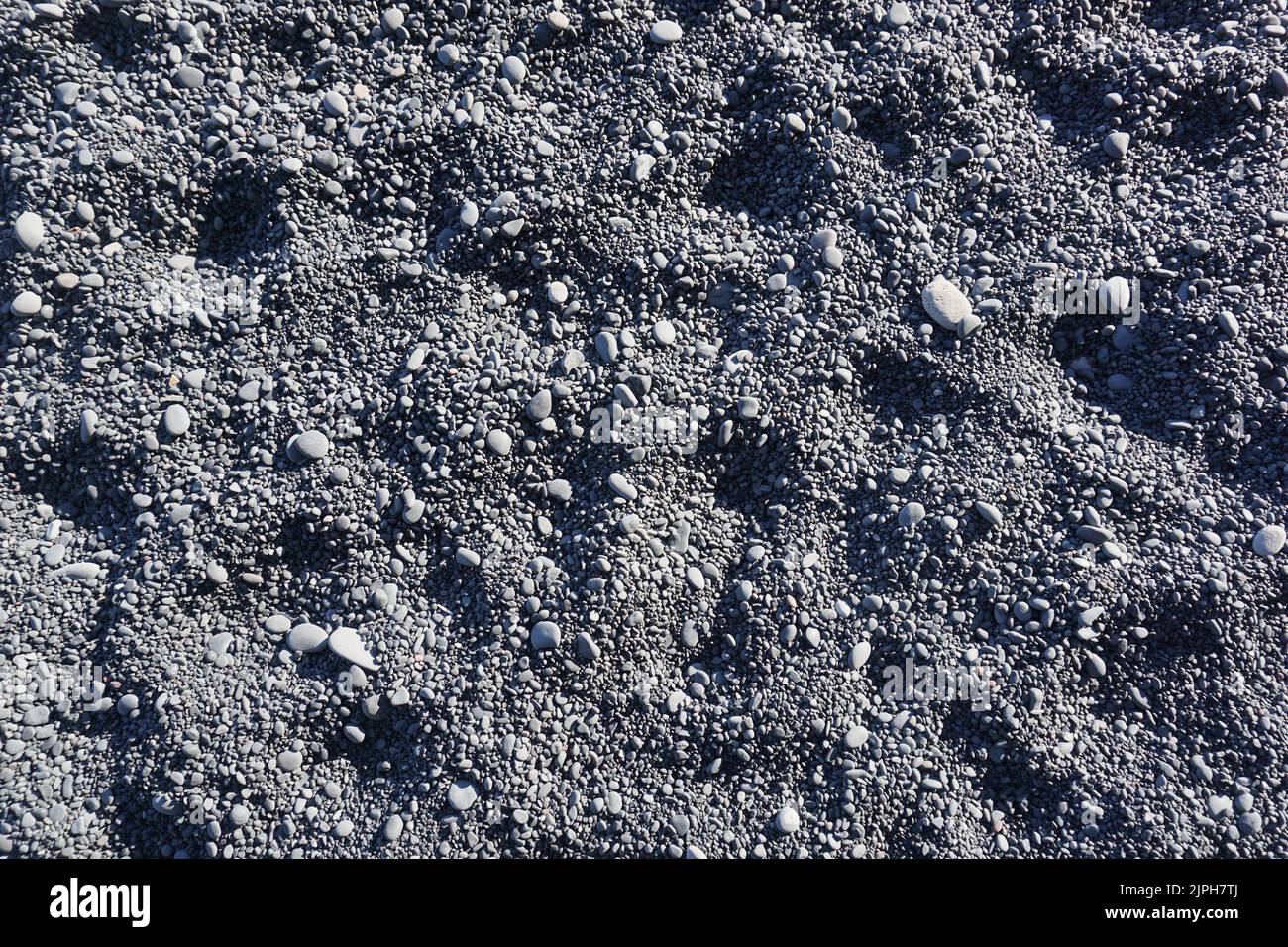 Black sand and pebbles - top view Stock Photo - Alamy