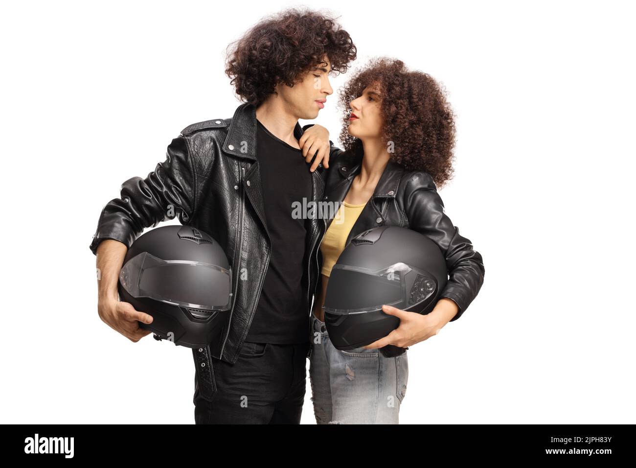 Young couple in leather jackets holding motorbike helmets isolated on white background Stock ...