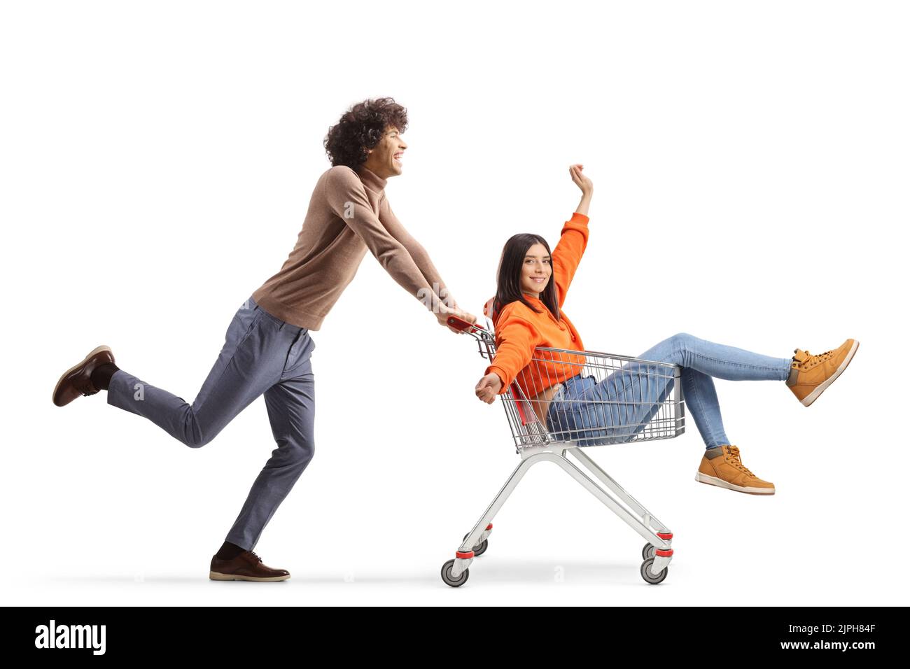Full length profile shot of a young man running and pushing a girl ...