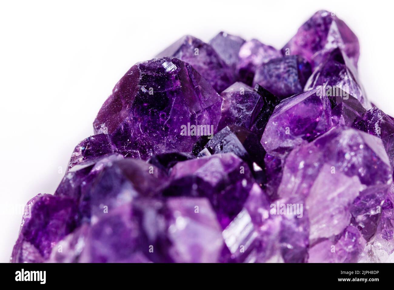 Macro mineral stone purple amethyst in crystals on a white background ...