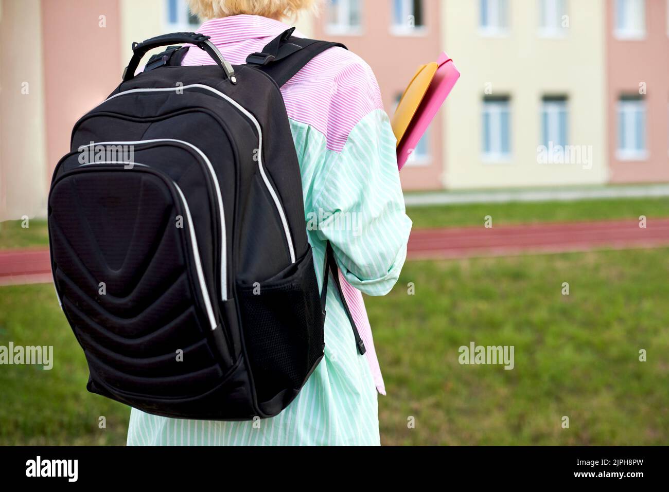 Student female with black backpack and folders for notebooks and books ...