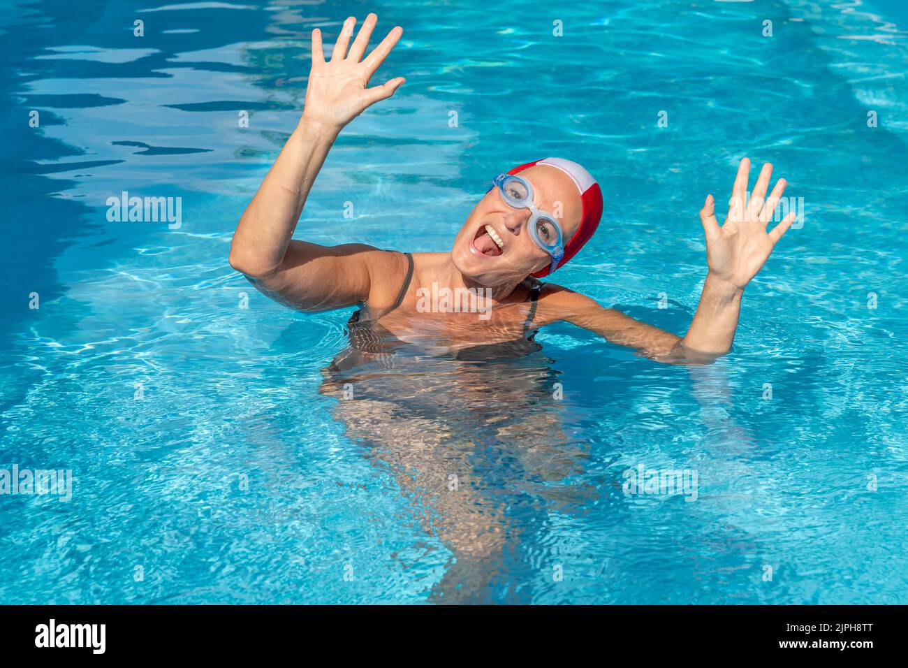 Middle Aged White Woman Is Having Fun In The Water Of A Swimming Pool