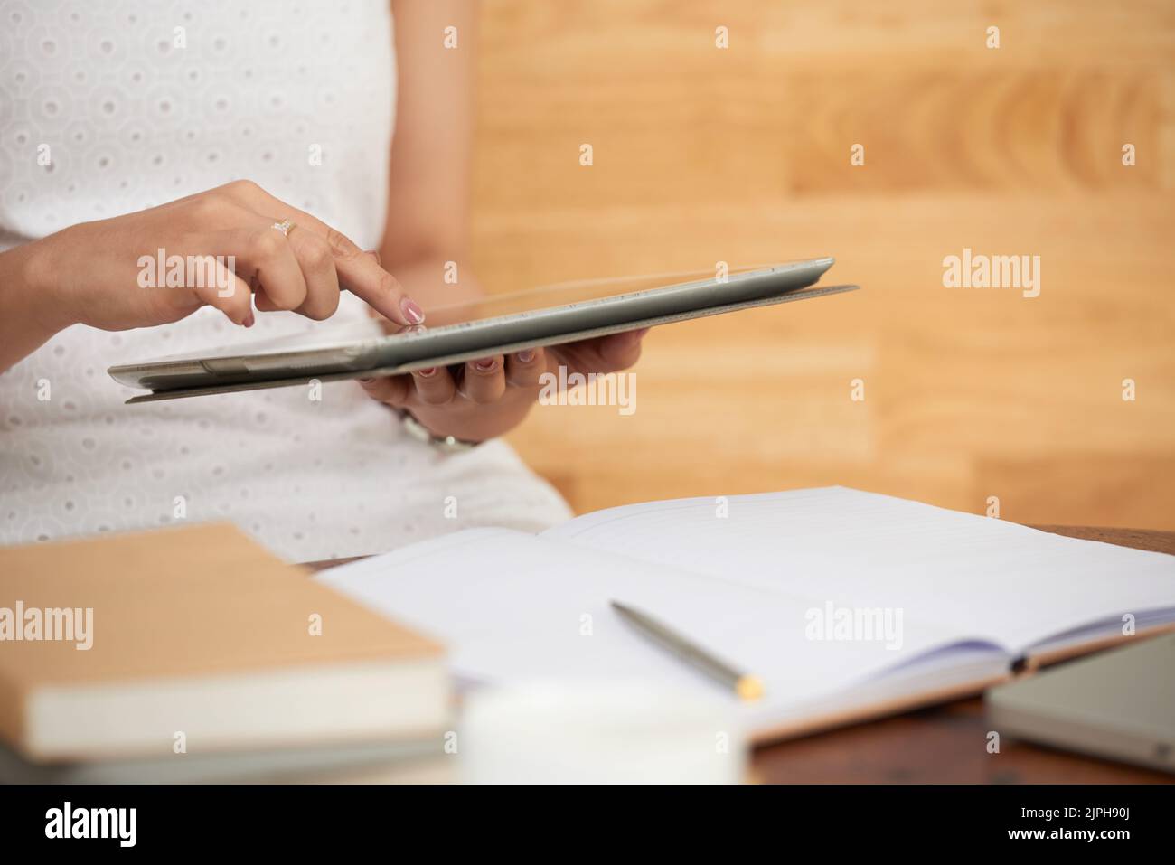 WOman using digital table when working on financial report Stock Photo ...