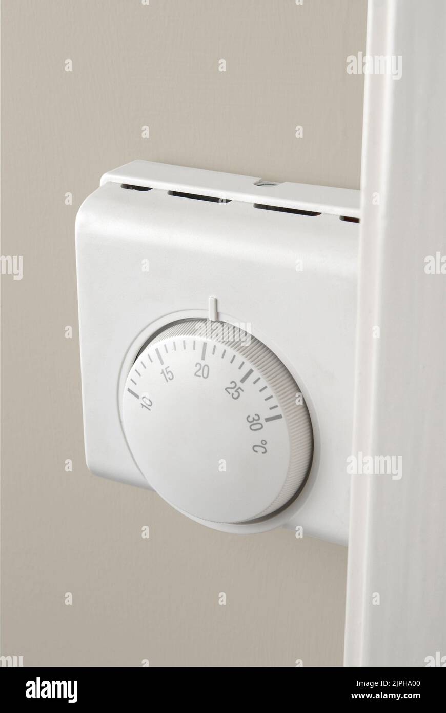 Central Heating temperature thermostat fixed on the wall close up Stock ...