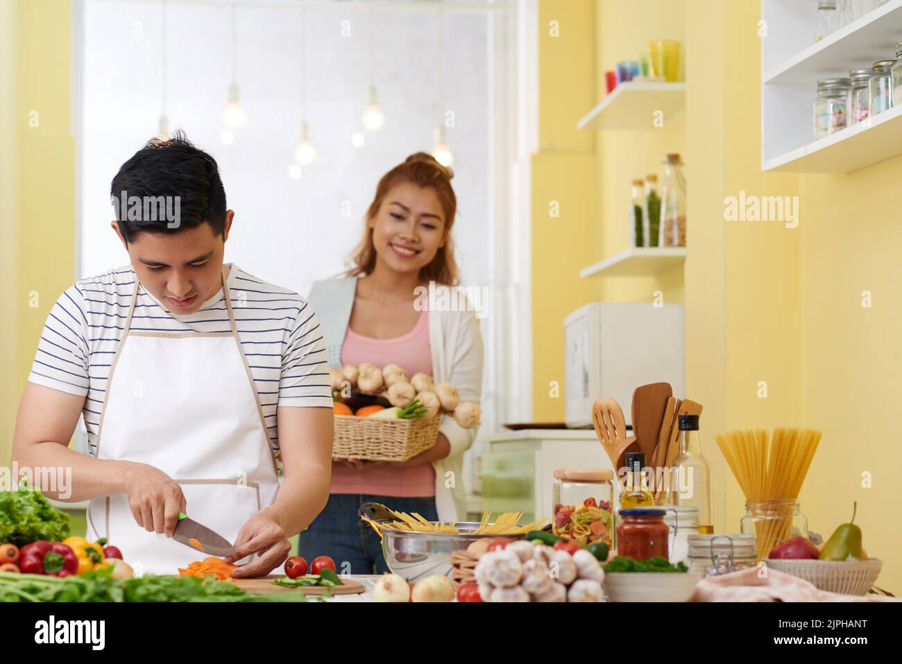 Young Asian couple enjoying cooking dinner together Stock Photo - Alamy
