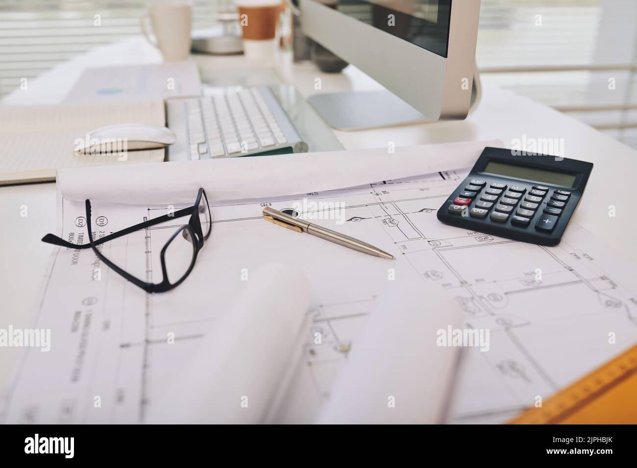 Construction plan and calculator on table on engineer Stock Photo - Alamy