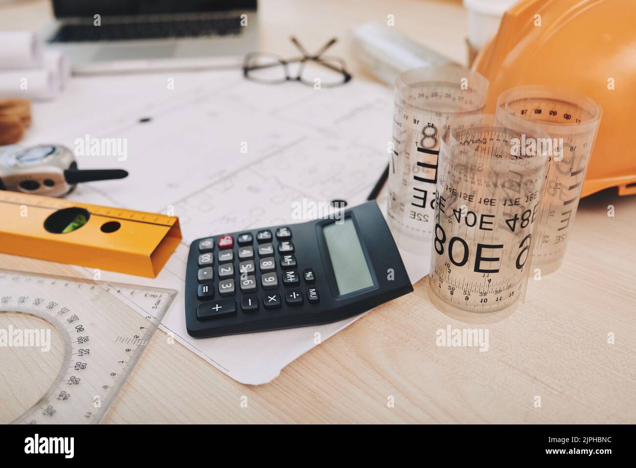 Flexible ruler and calculator on table of engineer Stock Photo - Alamy